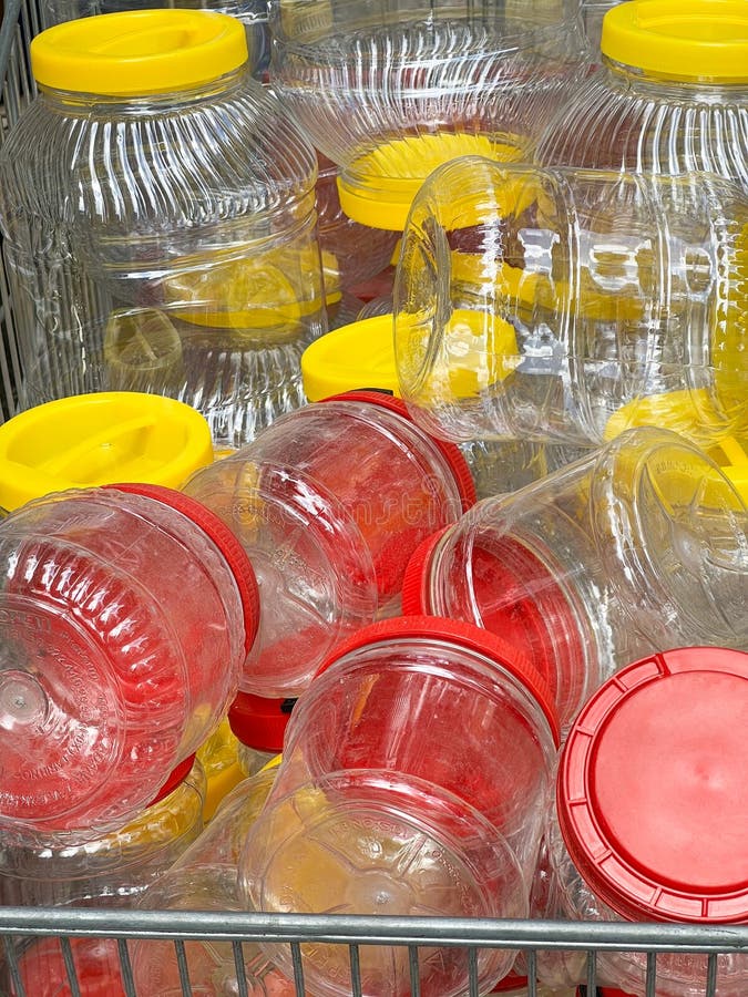 Pile of Cans of Different Sizes and Shapes with Red and Yellow Lids ...