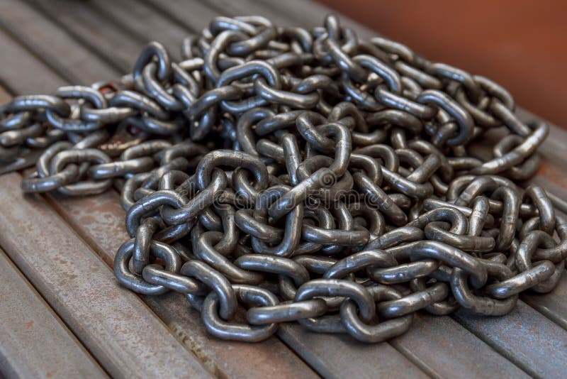 A Pile of Chain Rests on a Bundle of Rolled Metal Pipe. Stock Image ...