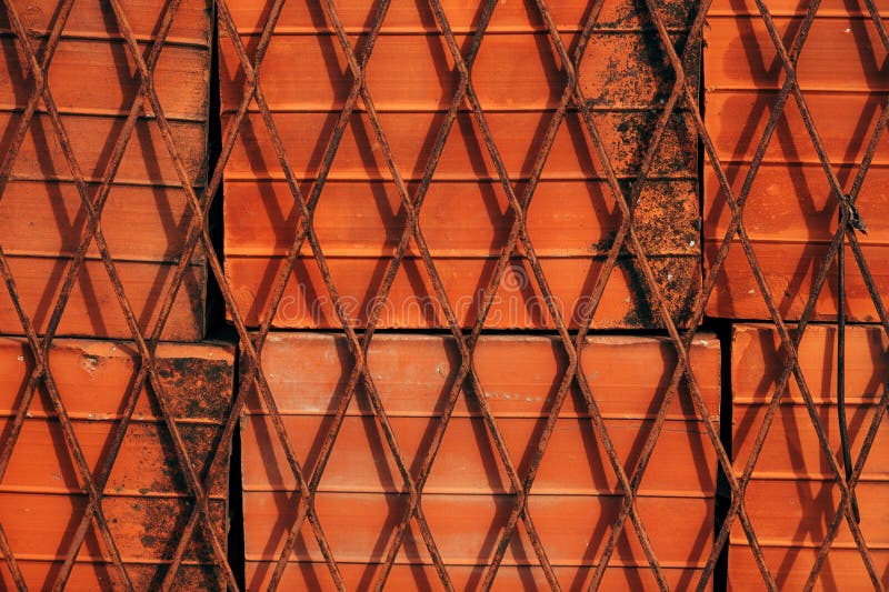 Pile of Clay Construction Blocks Behind Worn Rusty Fence Stock Photo ...
