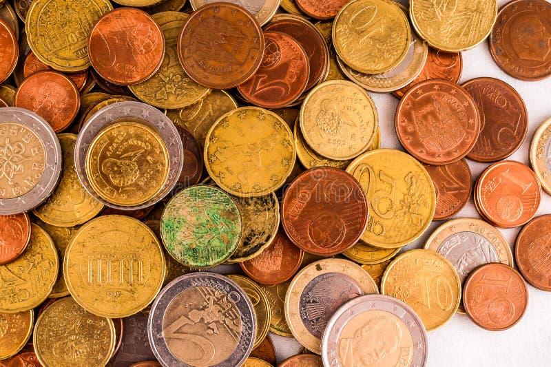 A Pile of Coins with a Green Coin in the Middle Stock Photo - Image of ...