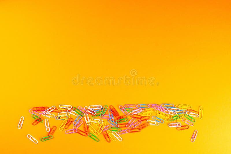 A Pile of Colored Paper Clips Scattered on a Orange Surface Stock Image ...