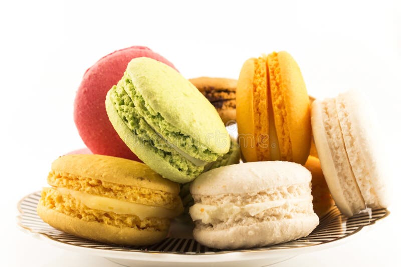 A Pile of Colorful Macaroons on a Plate Isolated on White Background ...