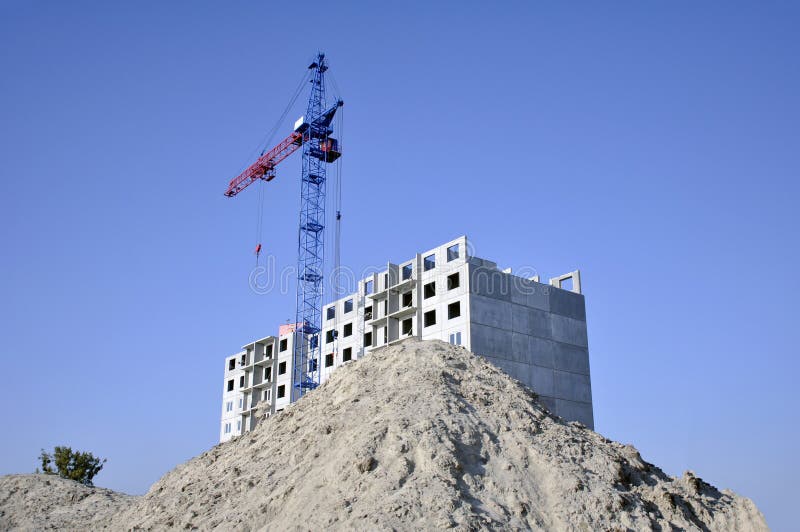 A Pile of Construction Sand in Front of Buildings Under Construction ...