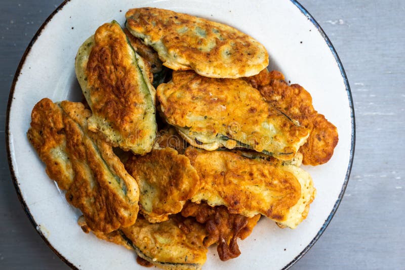 A Pile of Courgette Fritters in Batter in a Plate on Grey Table ,top ...