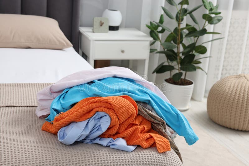 Pile of Different Clothes on Bed at Home Stock Image - Image of ...