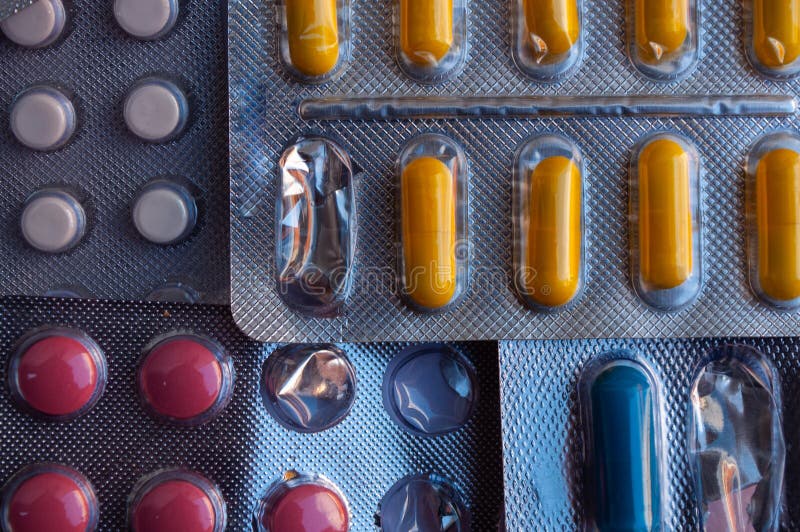 Pile of Different Colored Tablets in a Half Open Blister Pack ...