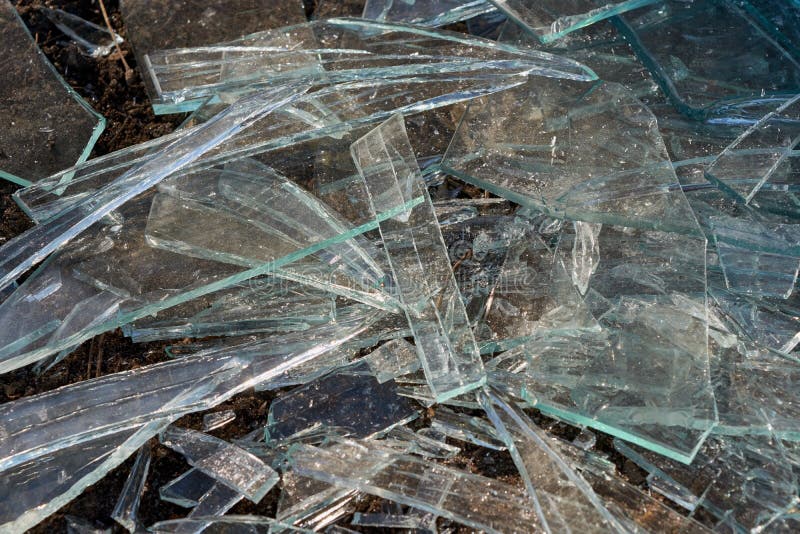 A Pile of Different Sharp Pieces of Broken Glass Lying on the Ground ...
