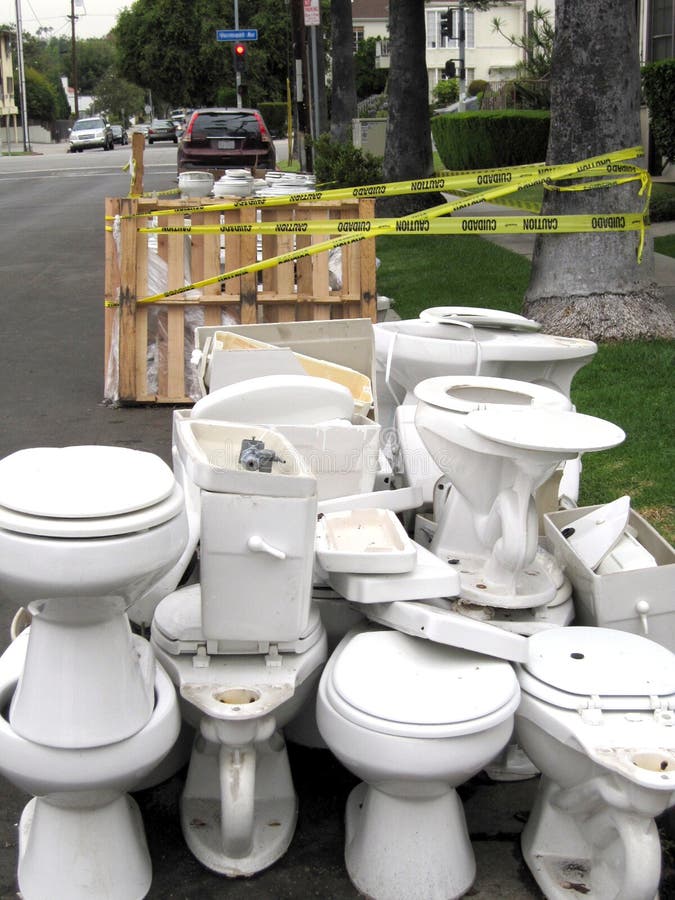 Pile of discarded toilets stock photo. Image of replace - 61933432