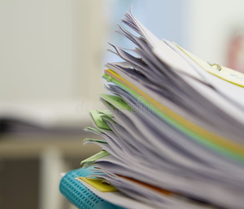 Pile of Documents and Blue File in Office Background Stock Image ...