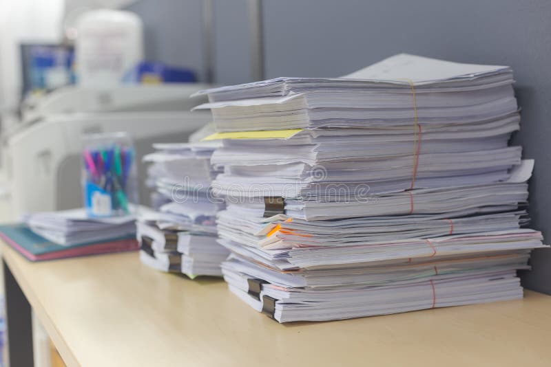 Pile of Documents on Desk Stack Up High Waiting To Be Managed Stock ...
