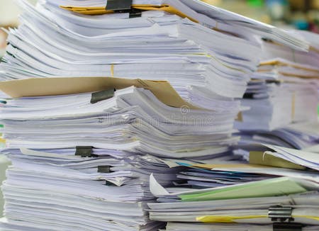 Pile of Documents on Desk Stack Up High Waiting To Be Managed Stock ...