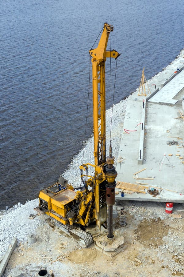 Pile Driver at the Construction of New Embankment on the River Bank ...