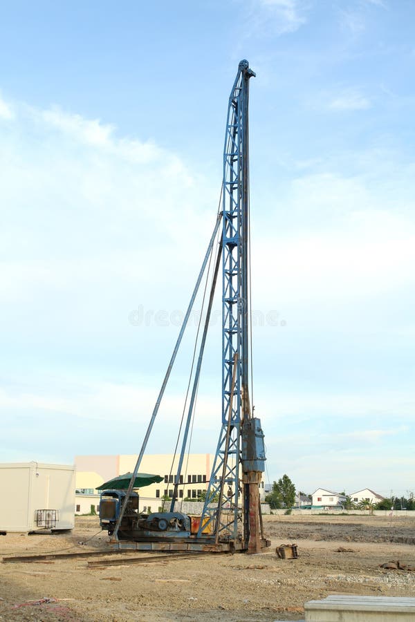 Pile Driving in Foundation Pit for Construction of Apartment Building. Deep Installation and ...