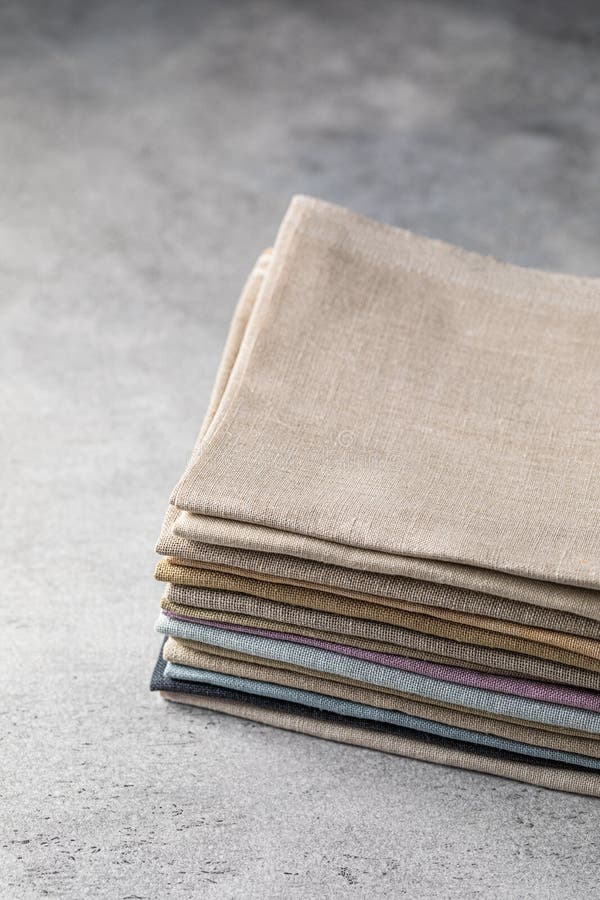 A Pile of Four Folded Dull-colored Natural Linen Fabric Stock Photo ...
