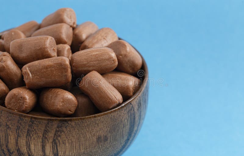 A Pile of Freeze Dried Chocolate Candy Rolls Isolated on a Blue ...