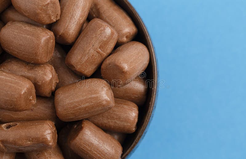 A Pile of Freeze Dried Chocolate Candy Rolls Isolated on a Blue ...