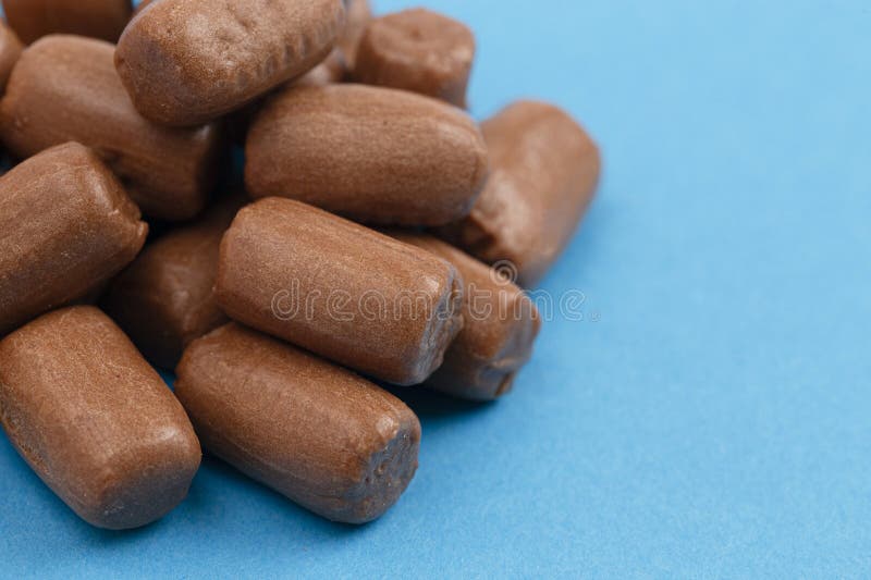 A Pile of Freeze Dried Chocolate Candy Rolls Isolated on a Blue ...
