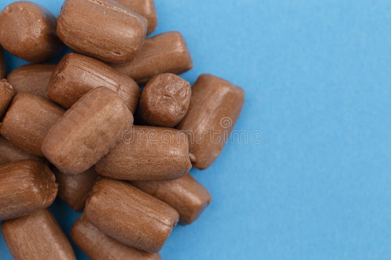 A Pile of Freeze Dried Chocolate Candy Rolls Isolated on a Blue ...