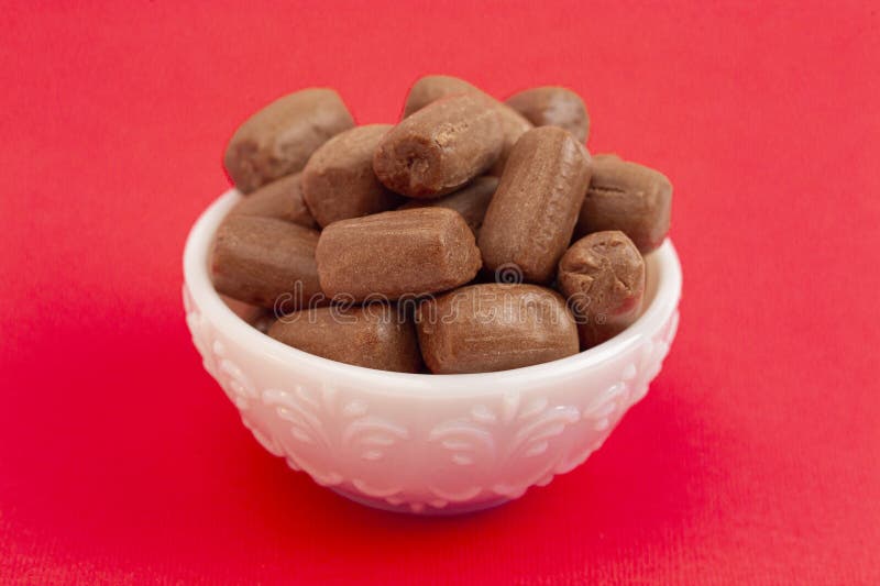 A Pile of Freeze Dried Chocolate Candy Rolls Isolated on a Blue ...