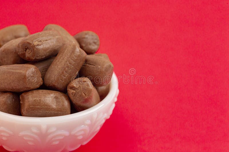 Pile of Freeze Dried Chocolate Candy Rolls Isolated on a Red Background ...