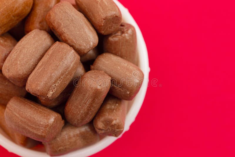A Pile of Freeze Dried Chocolate Candy Rolls Isolated on a Blue ...