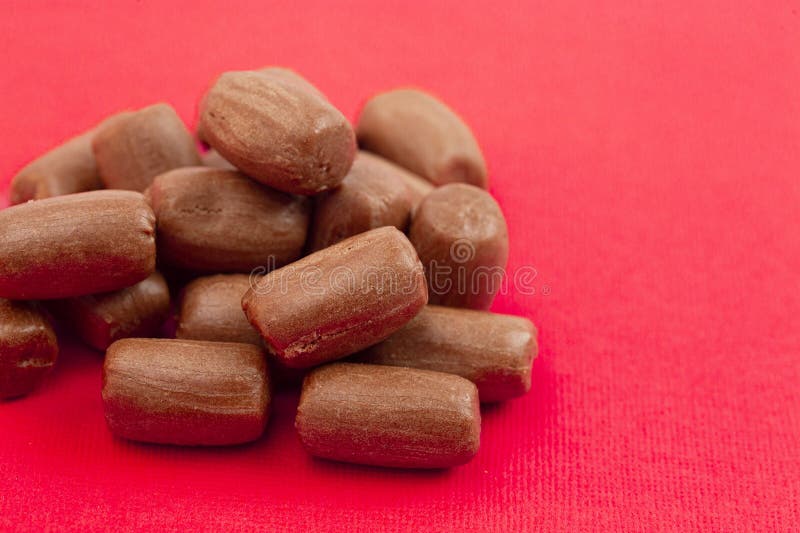 A Pile of Freeze Dried Chocolate Candy Rolls Isolated on a Blue ...