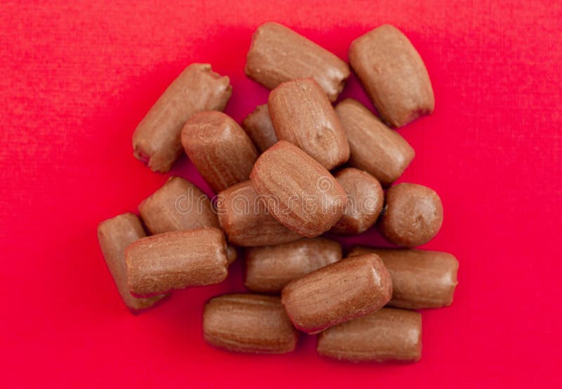 A Pile of Freeze Dried Chocolate Candy Rolls Isolated on a Blue ...