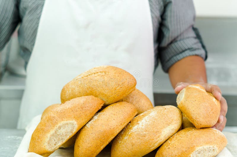 Pile of Fresh Bread Loafs, Baker Standing Behind with only Apren and ...