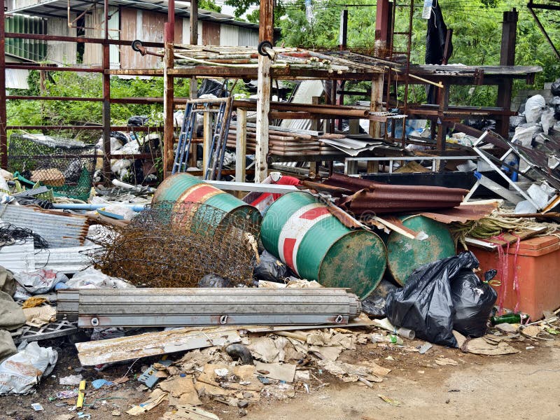 A Pile of Garbage with a Bucket, Rope, Bottles, and Other Items at a ...