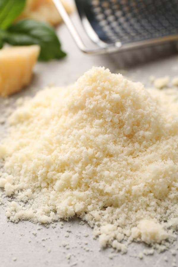 Pile of Grated Parmesan Cheese on Light Table, Closeup Stock Photo ...
