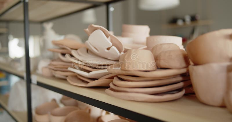 A Pile of Hand Made Ceramic Dishes Lying on a Rack in a Pottery ...