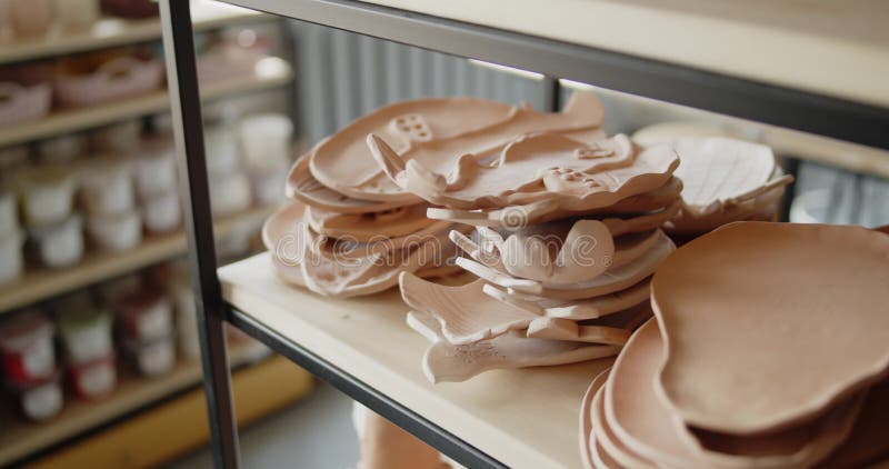 A Pile of Hand Made Ceramic Dishes Lying on a Rack in a Pottery ...
