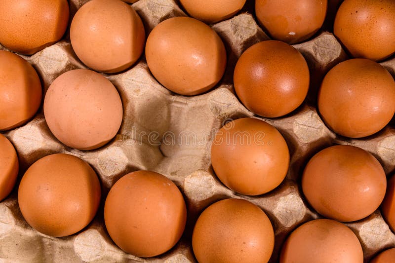 Pile of the Hen Eggs in Paper Tray on Wooden Table. Top View Stock ...