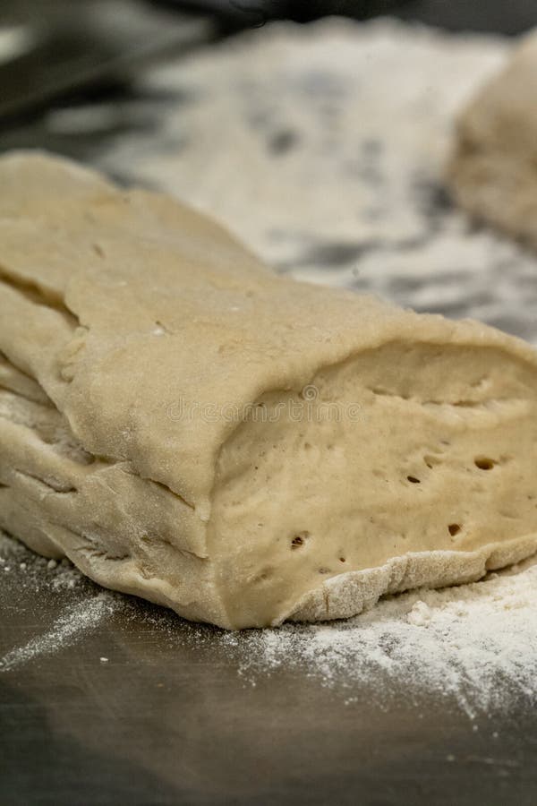 Pile of Homemade Bread Dought on a Table with a Lot of Flour Around it ...