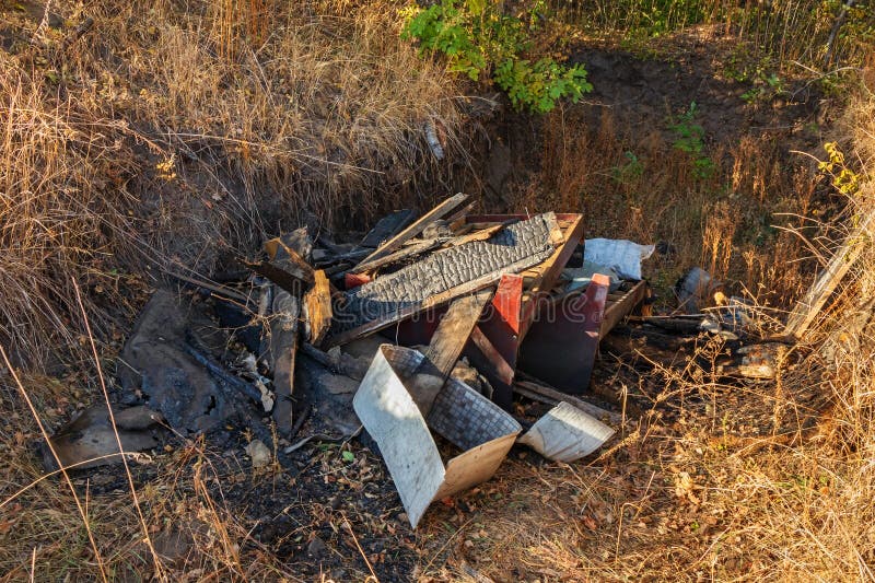 A Pile of Household Garbage and Burnt Boards in a Pit. a Spontaneous ...