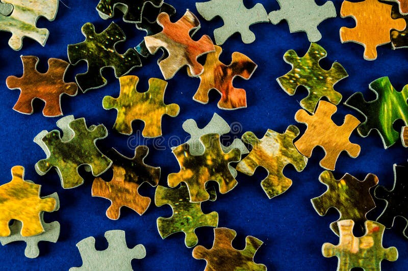 A Pile of Jigsaw Puzzle Pieces with a Blue Background Stock Photo ...
