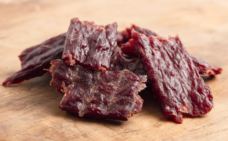 Pile of Kippered Beef Steak Beef Jerky on a Rustic Wooden Table Stock ...