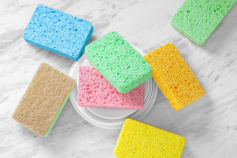 Pile of Kitchen Washing Sponge with Plates on White Marble Table Stock ...