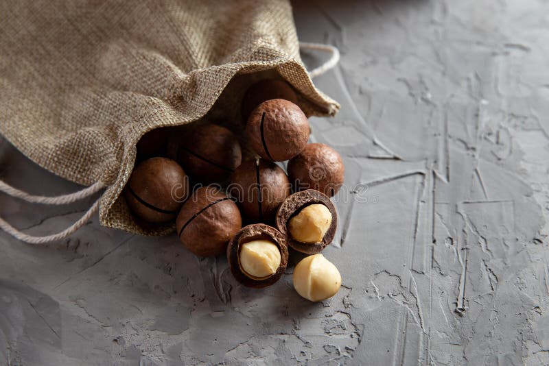 Pile of Macadamia Nuts in Whole Kernels and Half Opened on Wooden ...