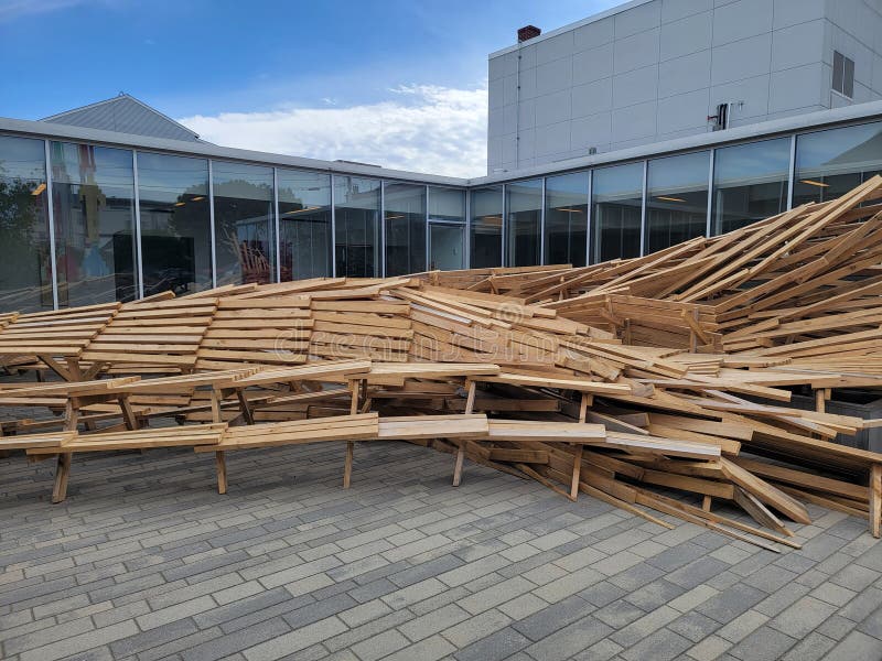 Pile or Mound of Wood Tables Outside Building with Windows Stock Photo ...