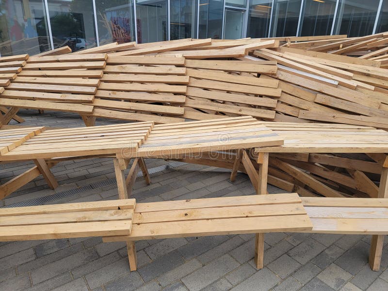 Pile or Mound of Wood Tables Outside Building with Windows Stock Photo ...