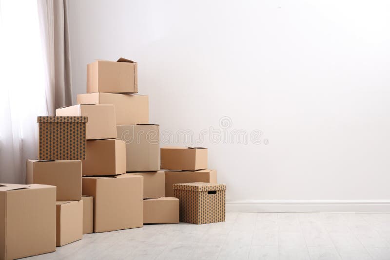 Pile of Moving Boxes in Room, Space for Text Stock Photo - Image of ...