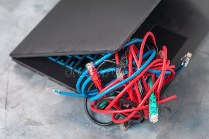 A Pile of Network Wires and a Laptop on the Table, a Concept on the ...