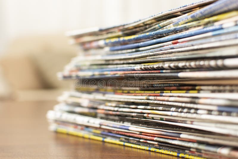 Pile of Newspapers Lying on the Wooden Table with Blurred Background ...