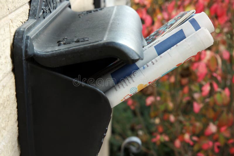 A Pile of Newspapers on a Mail Box Stock Photo - Image of letter ...