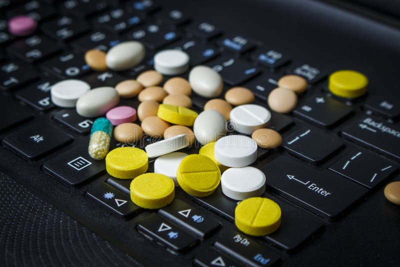 A Pile of Pills on the Keyboard Stock Photo - Image of care, painkiller ...