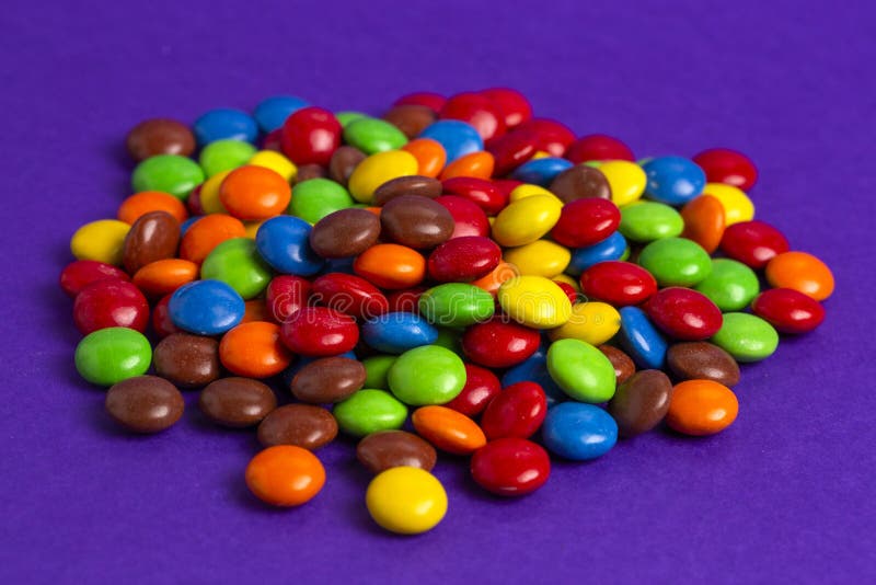 Pile of Rainbow Colored Candy Coated Chocolate Buttons Isolated on a ...