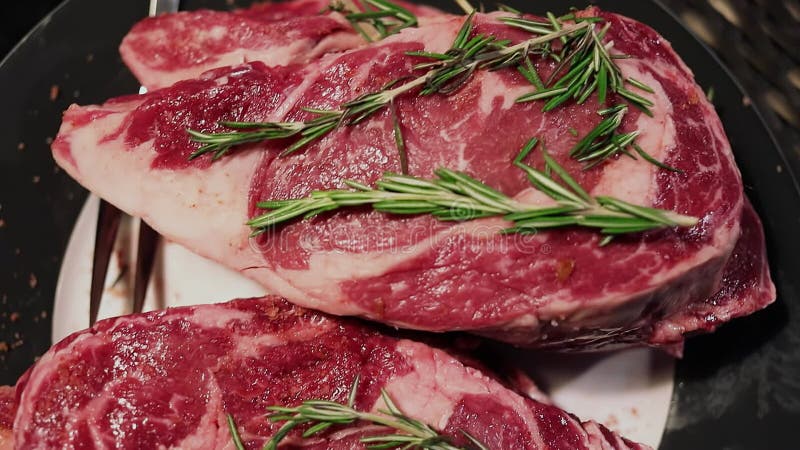 Pile of Raw Rib-eyes with Rosemary and Pepper on Stock Video - Video of ...