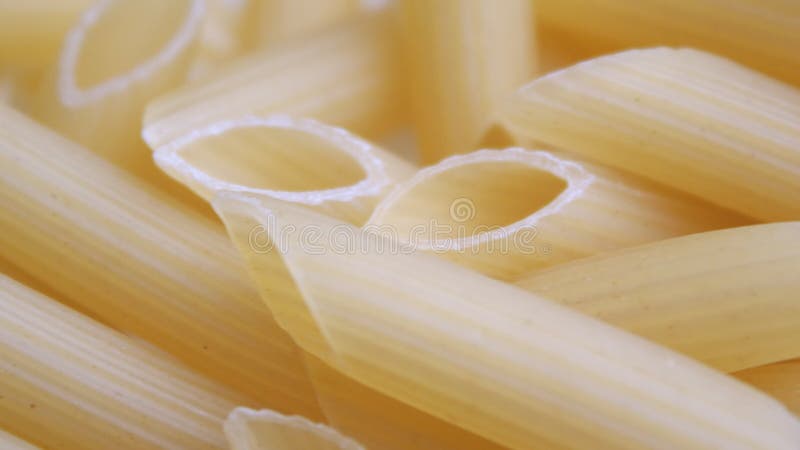 A Pile of Raw Yellow Pipe-shaped Pasta Lies on the Surface. Raw Pasta ...