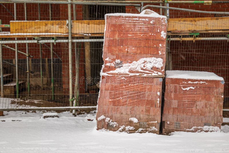 Pile of Red Building Construction Bricks Under Winter Snow in England ...